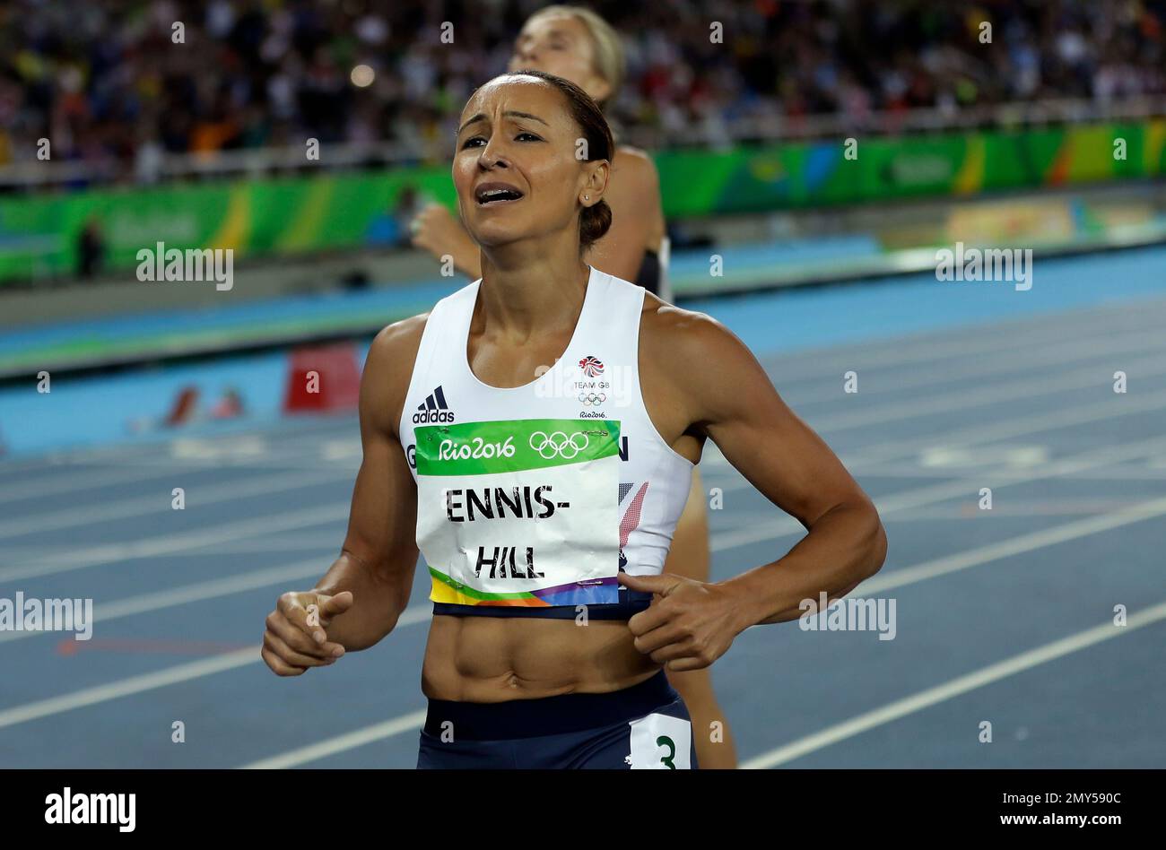 Britain's Jessica Ennis-Hill reacts after crossing the line in the ...