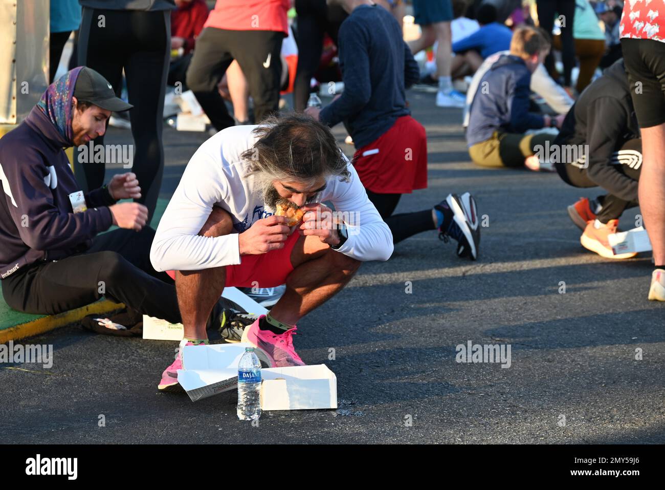 Raleigh, NC, USA, 4th February 2023, Runners wolf down one dozen Krispy ...