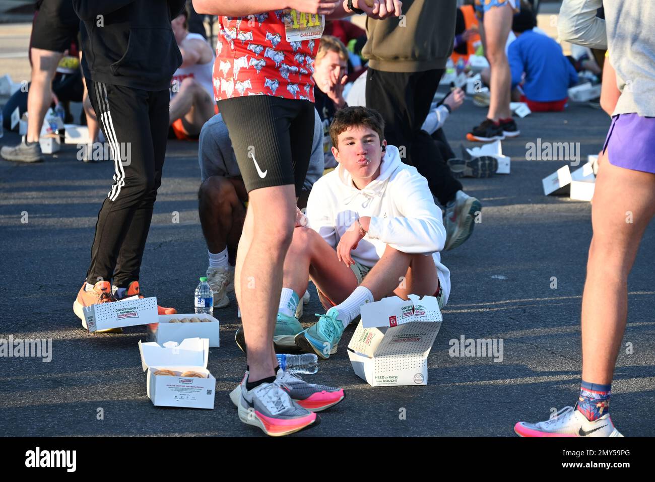 Raleigh, NC, USA, 4th February 2023, Runners wolf down one dozen Krispy ...