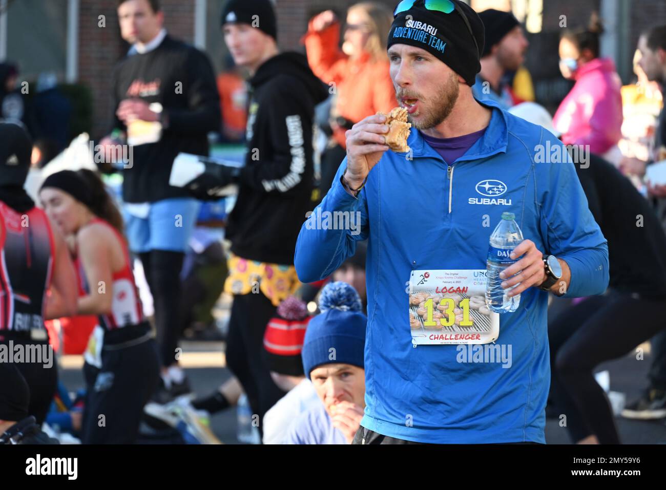 Raleigh, NC, USA, 4th February 2023, Runners wolf down one dozen Krispy ...