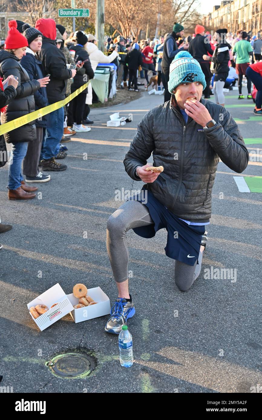 Raleigh, NC, USA, 4th February 2023, Runners wolf down one dozen Krispy ...