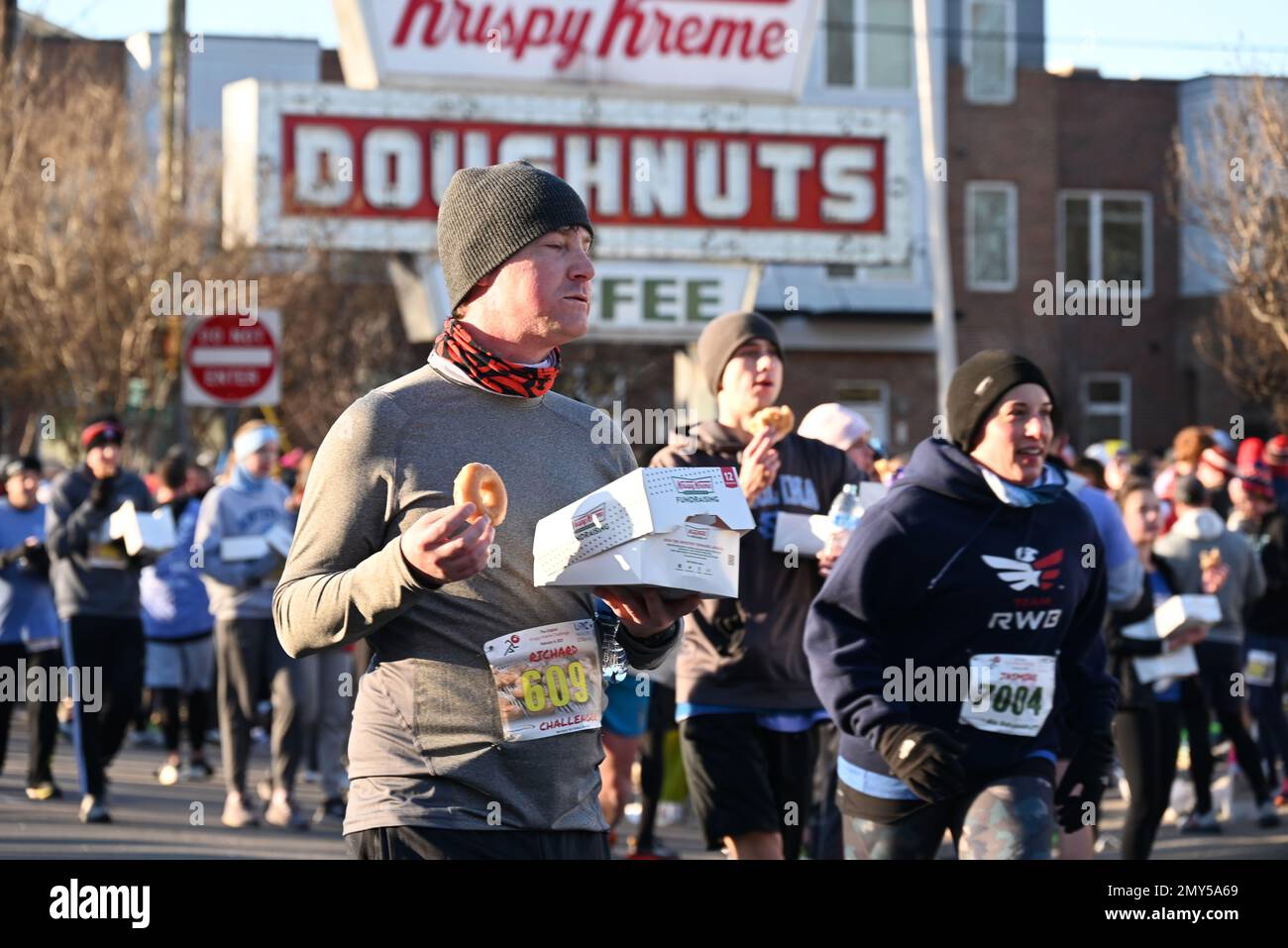 Raleigh, NC, USA, 4th February 2023, Runners wolf down one dozen Krispy ...