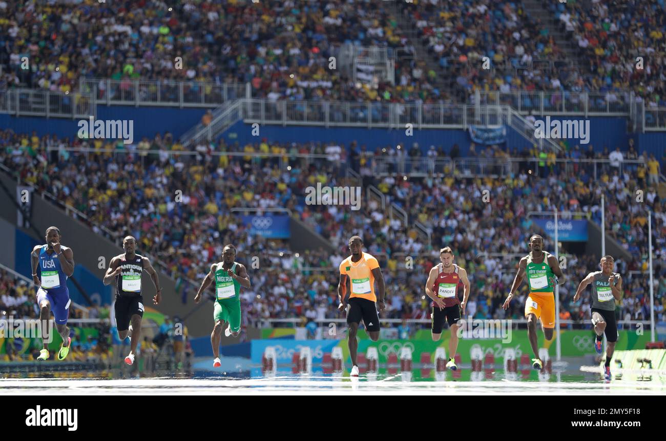 Athletes line up to compete in a men's 100-meter heat during the ...