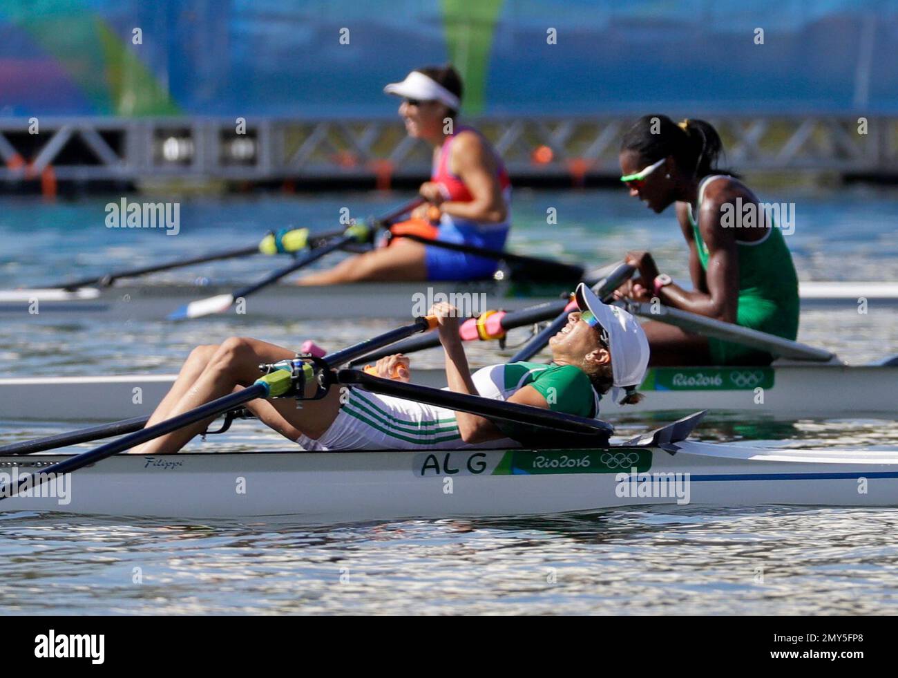 Amina Rouba, of Algeria, rests competing in the women's rowing single ...