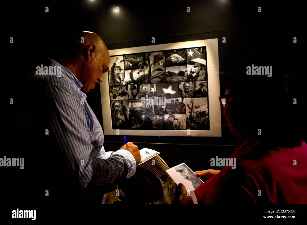 Alex Castro, left, son of Cuban Leader Fidel Castro, sings postcards ...