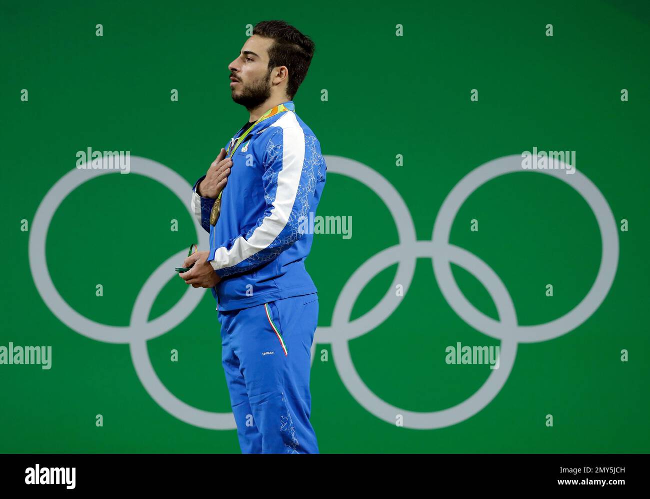 Gold medalist Kianoush Rostami, of Iran, sings along with the playing ...