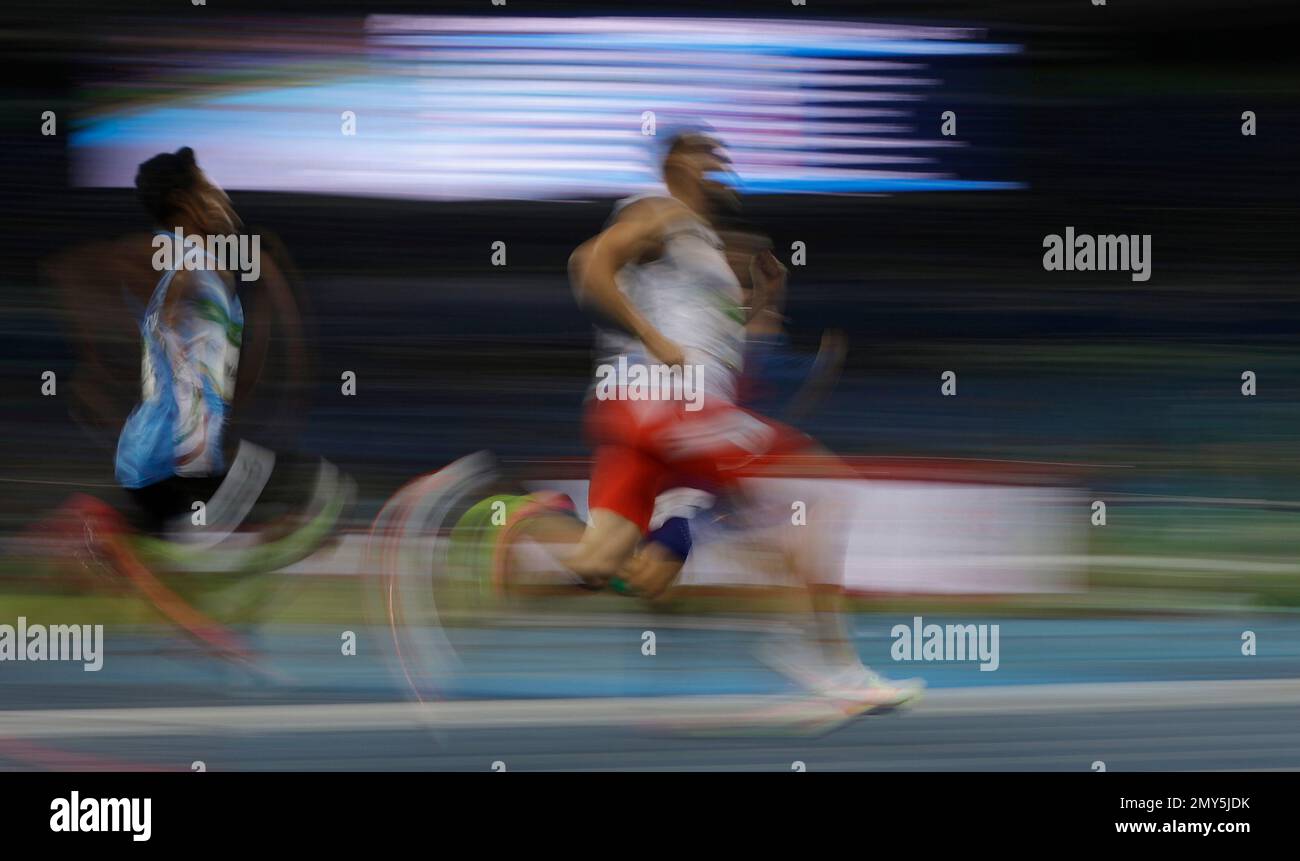 Athletes compete in a men's 400-meter heat during the athletics ...