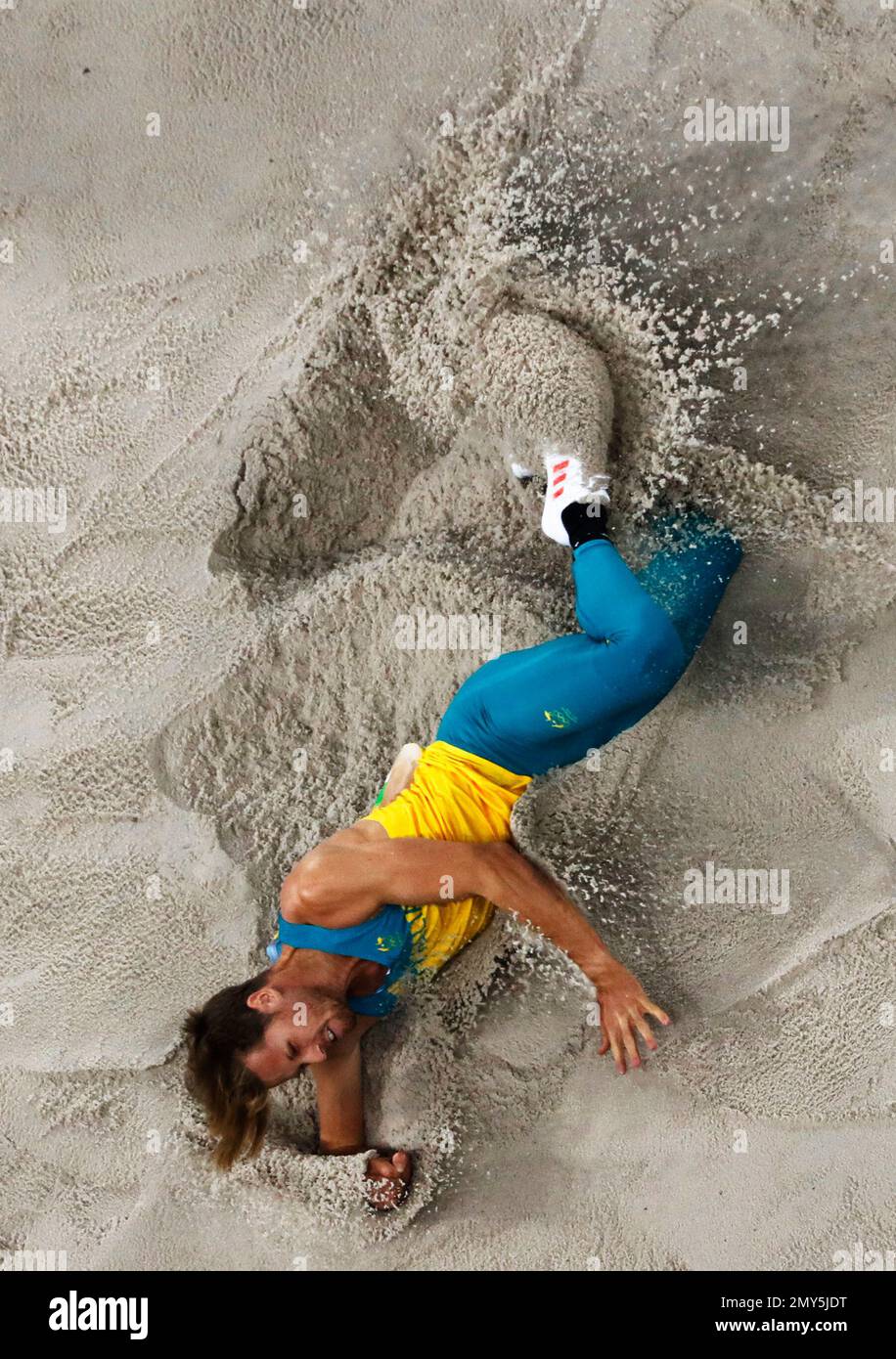 Australia's Henry Frayne lands after a long jump during the athletics ...