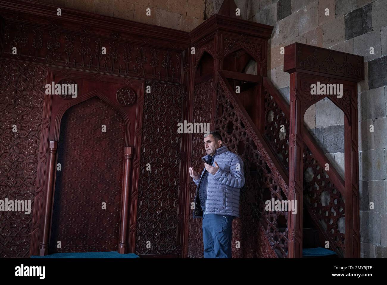 A man prays inside the mosque. Located in the Ani Ruins on the Turkey ...