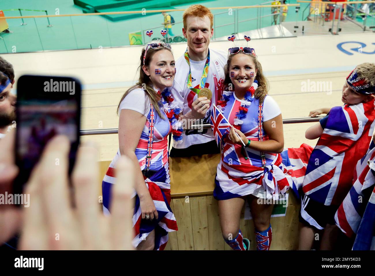 Gold medalist Edward Clancy of Britain, center, poses with fans after ...
