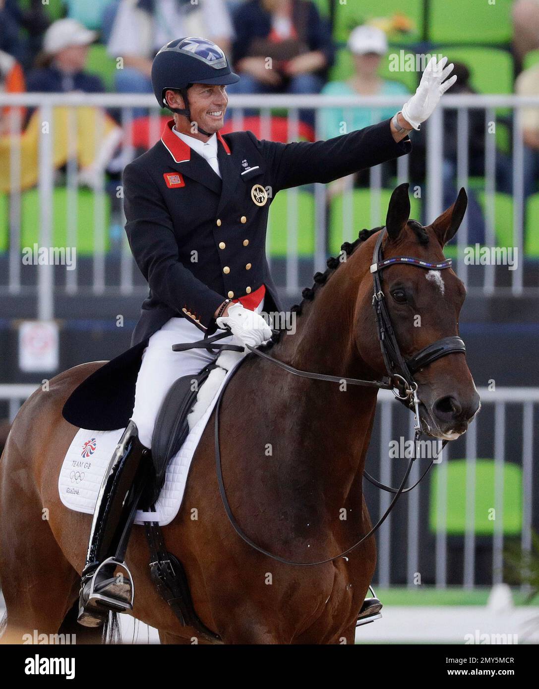 Britain's Carl Hester, riding Nip Tuck, reacts after competing in the ...