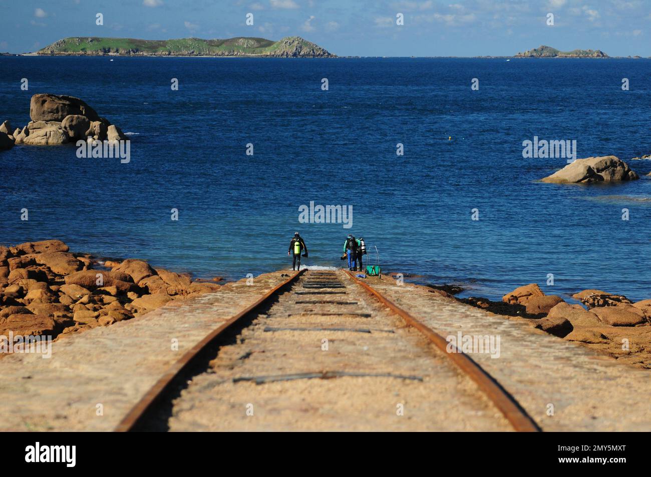 Divers Going Into The Water On The Beautiful Red Rock Coast In ...