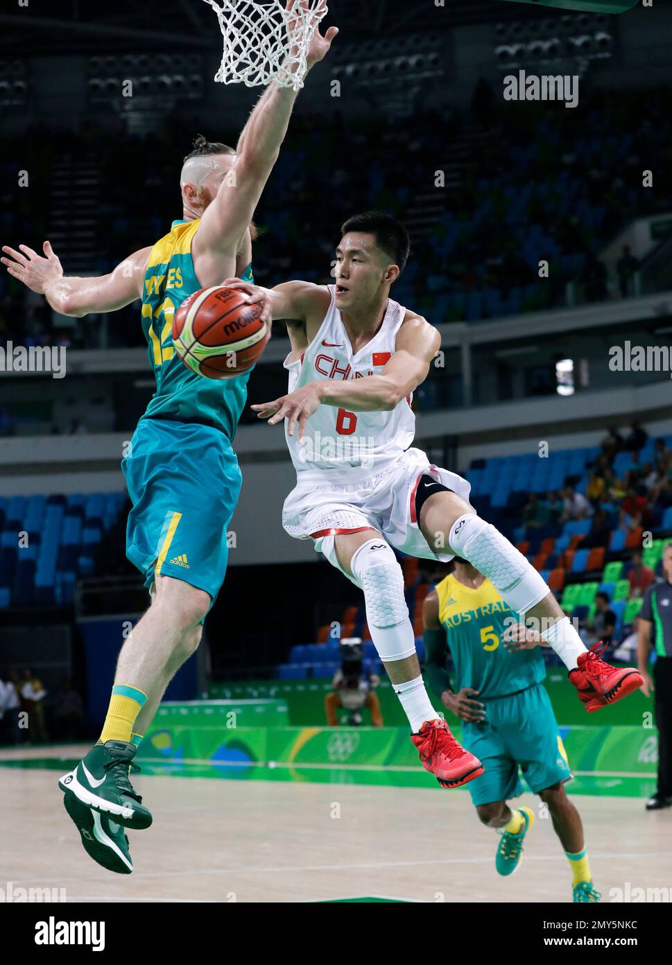 China's Guo Ailun (6) passes around Australia's Aron Baynes during a ...