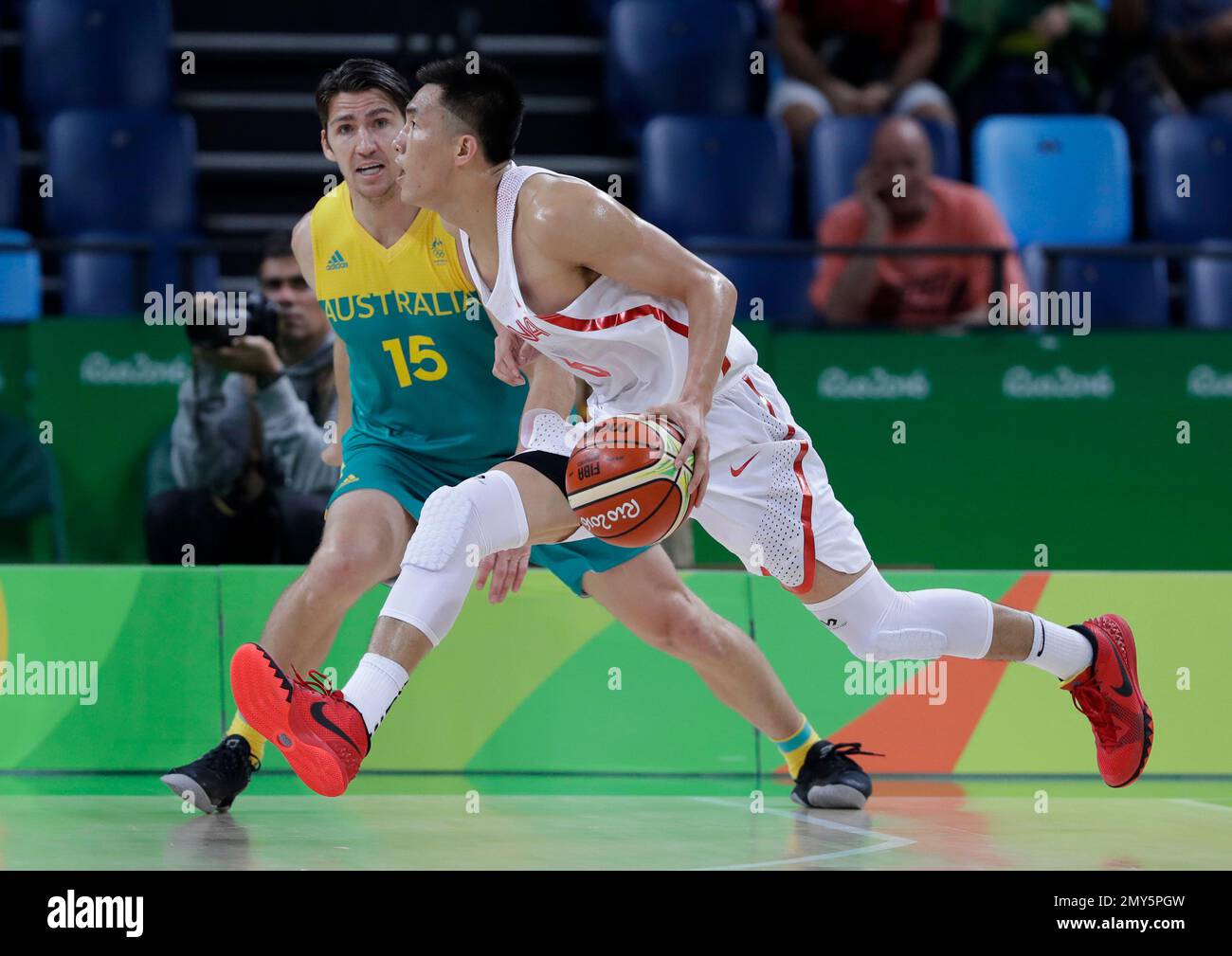 China's Guo Ailun (6) drives around Australia's Damian Martin (15 ...