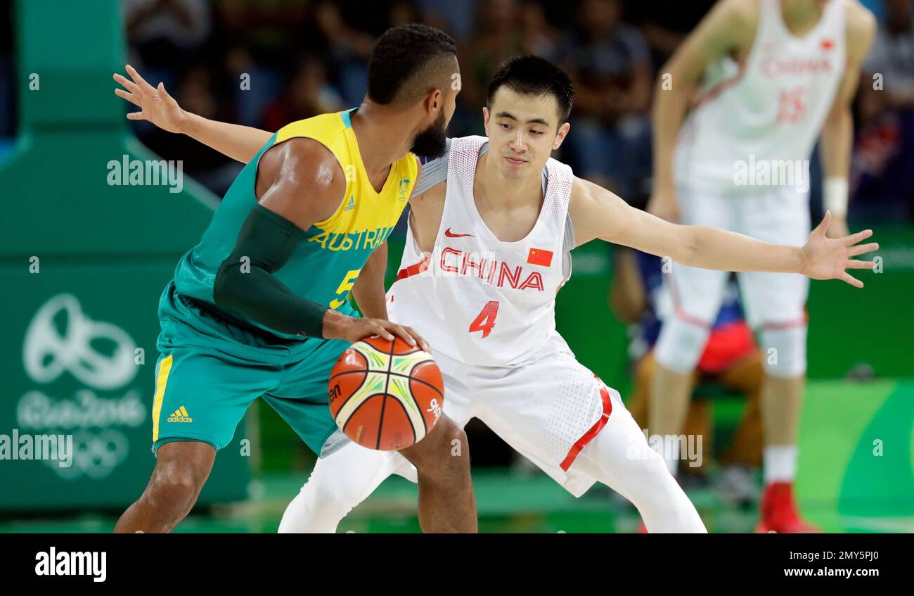 China's Zhao Jiwei (4) defends Australia's Patty Mills during a ...