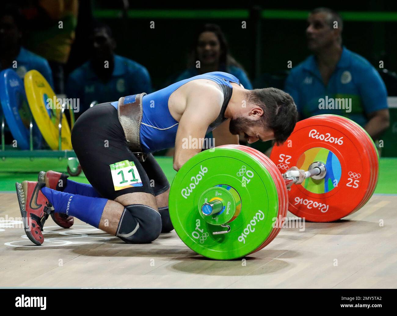 Theodoros Iakovidis, of Greece, kneels on the stage after failing to ...