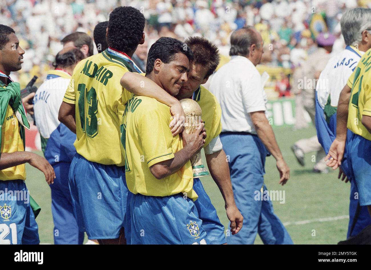 Brazil's star forward Romario holds the World Cup trophy to his chest ...