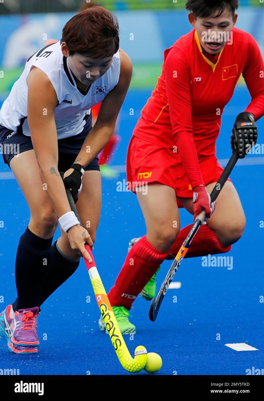South Korea's Kiju Park, left, fights for the ball with China's Mengyu ...