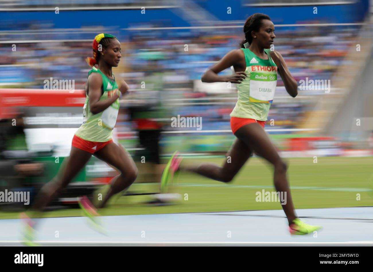 Ethiopia's Tirunesh Dibaba, right, competes in the women's 10,000-meter ...