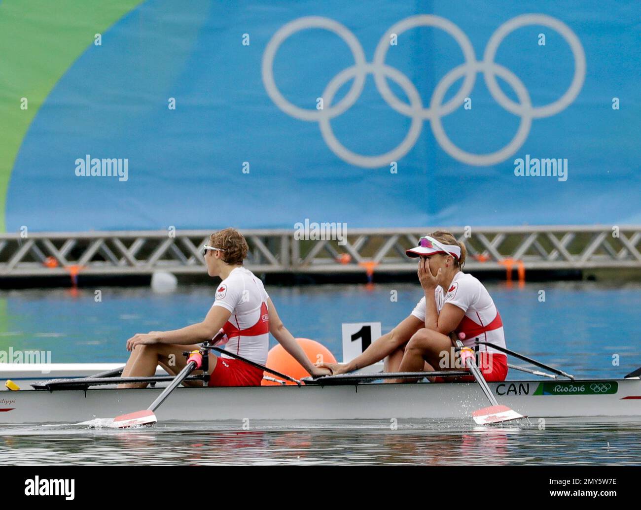 Lindsay Jennerich and Patricia Obee of Canada, react after finishing ...