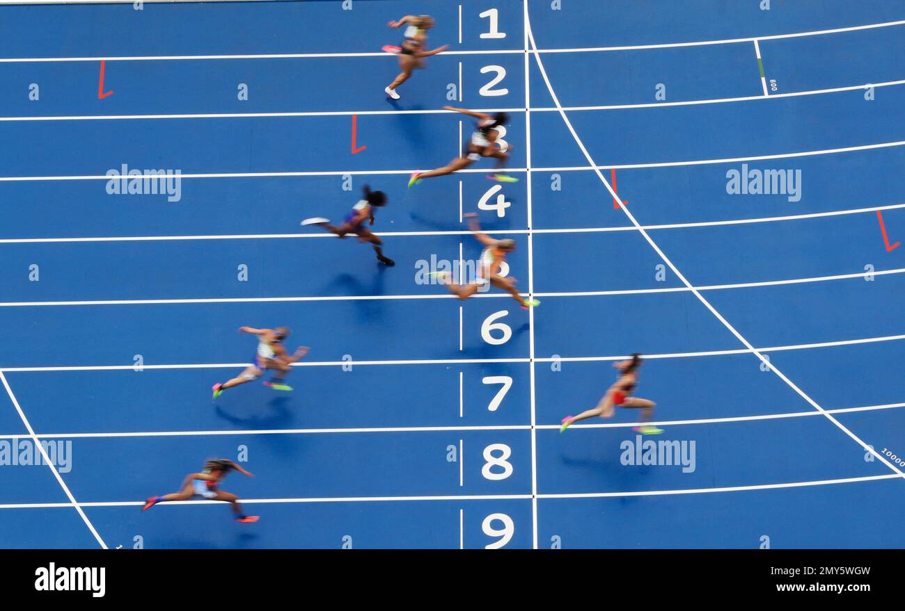Runners cross the finish line in the 100m hurdles in the women's ...