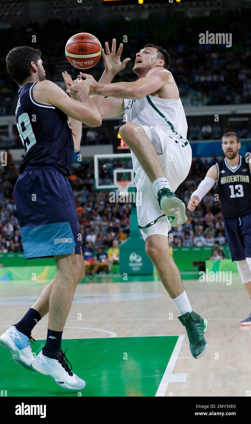 Lithuania's Jonas Maciulis, right, loses control of the ball as he ...