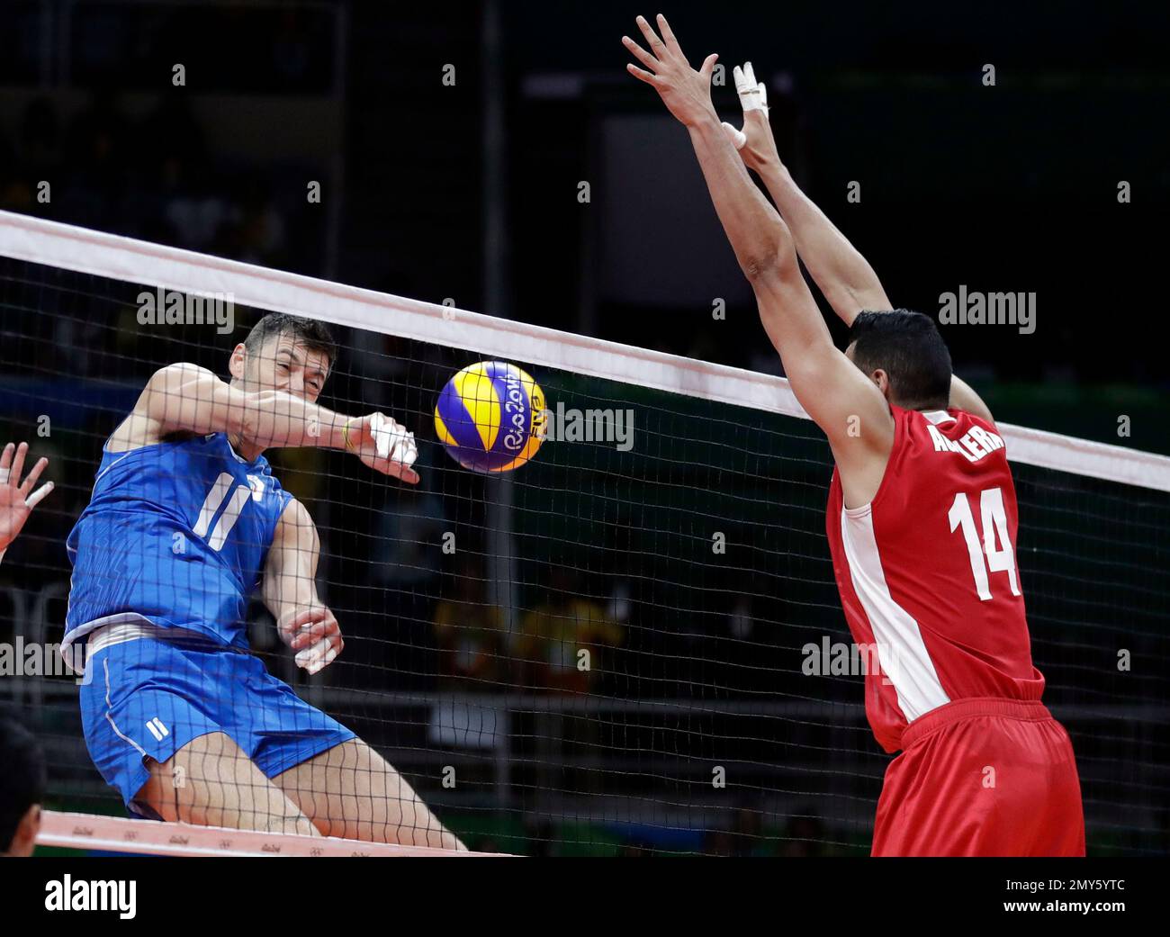 Italy's Simone Buti (11) spikes as Mexico's Tomas Aguilera (14) defends ...
