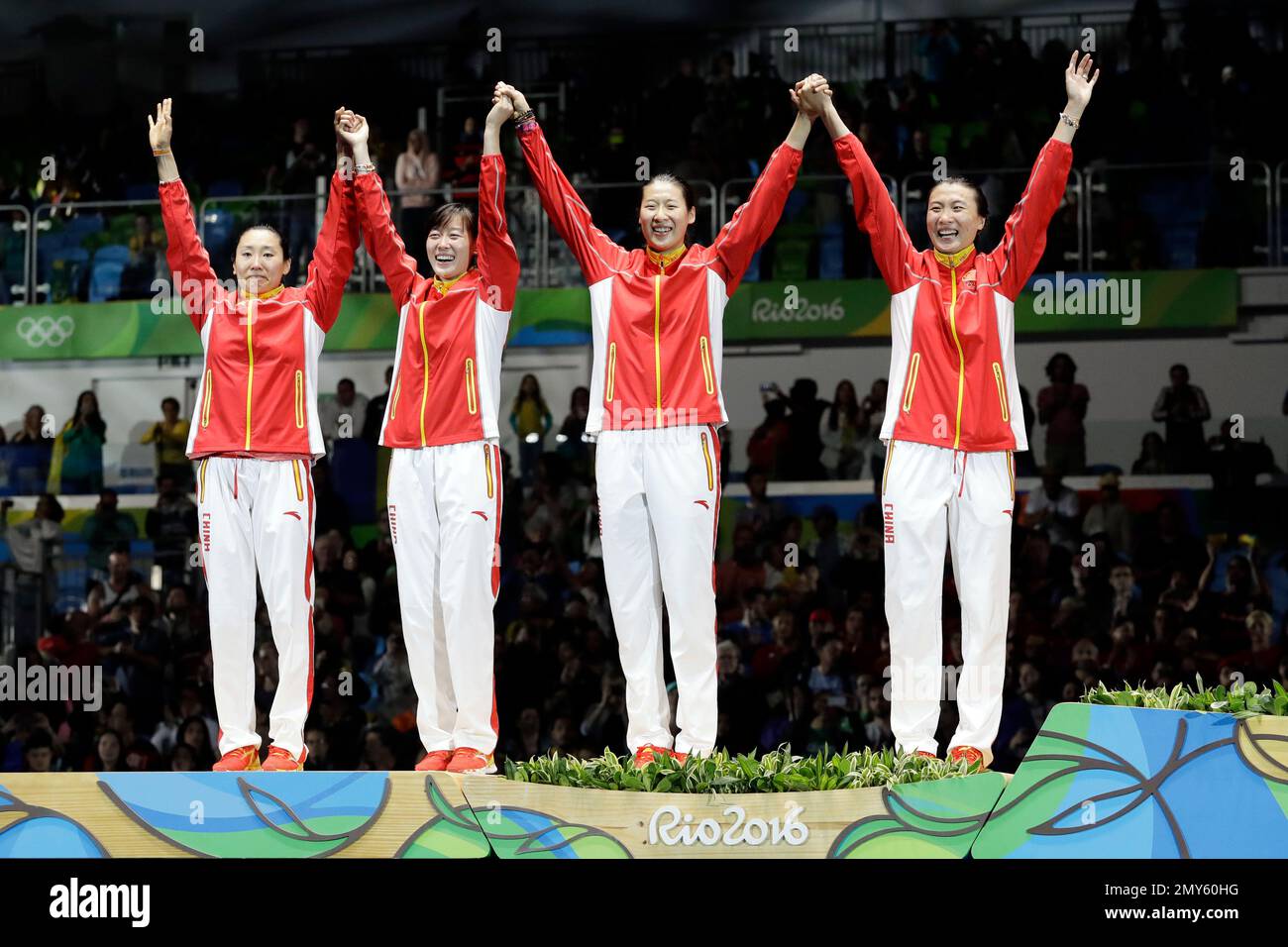 China's fencing team stand on the podium after winning the silver medal ...