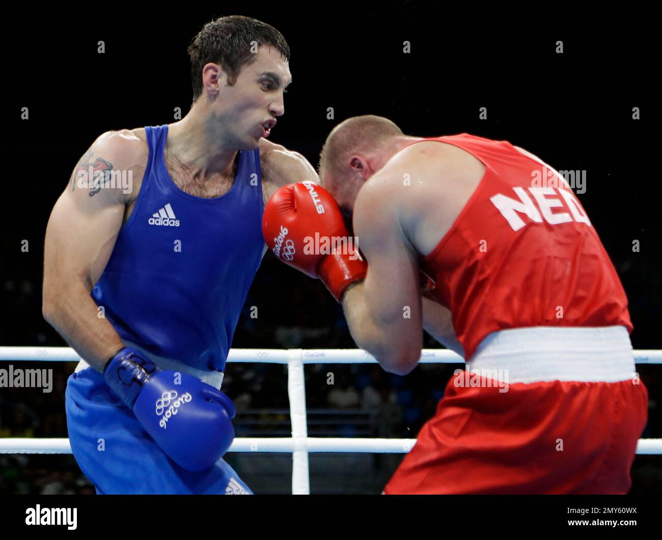 Azerbaijan's Teymur Mammadov, left, fights Netherlands' Peter Mullenberg during a men's light ...