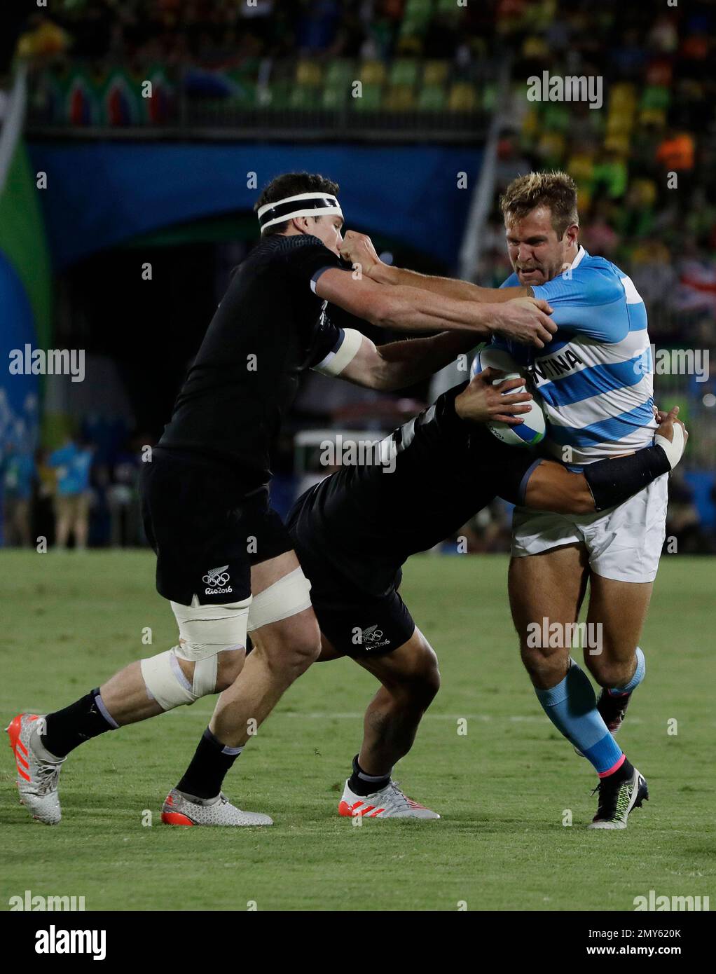 Argentina's Fernando Luna, right, is tackled by New Zealand's Sam ...