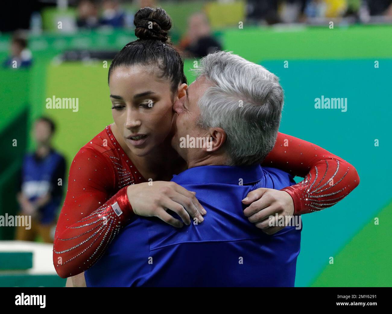 United States' Aly Raisman hugs a coach after her routine on the ...