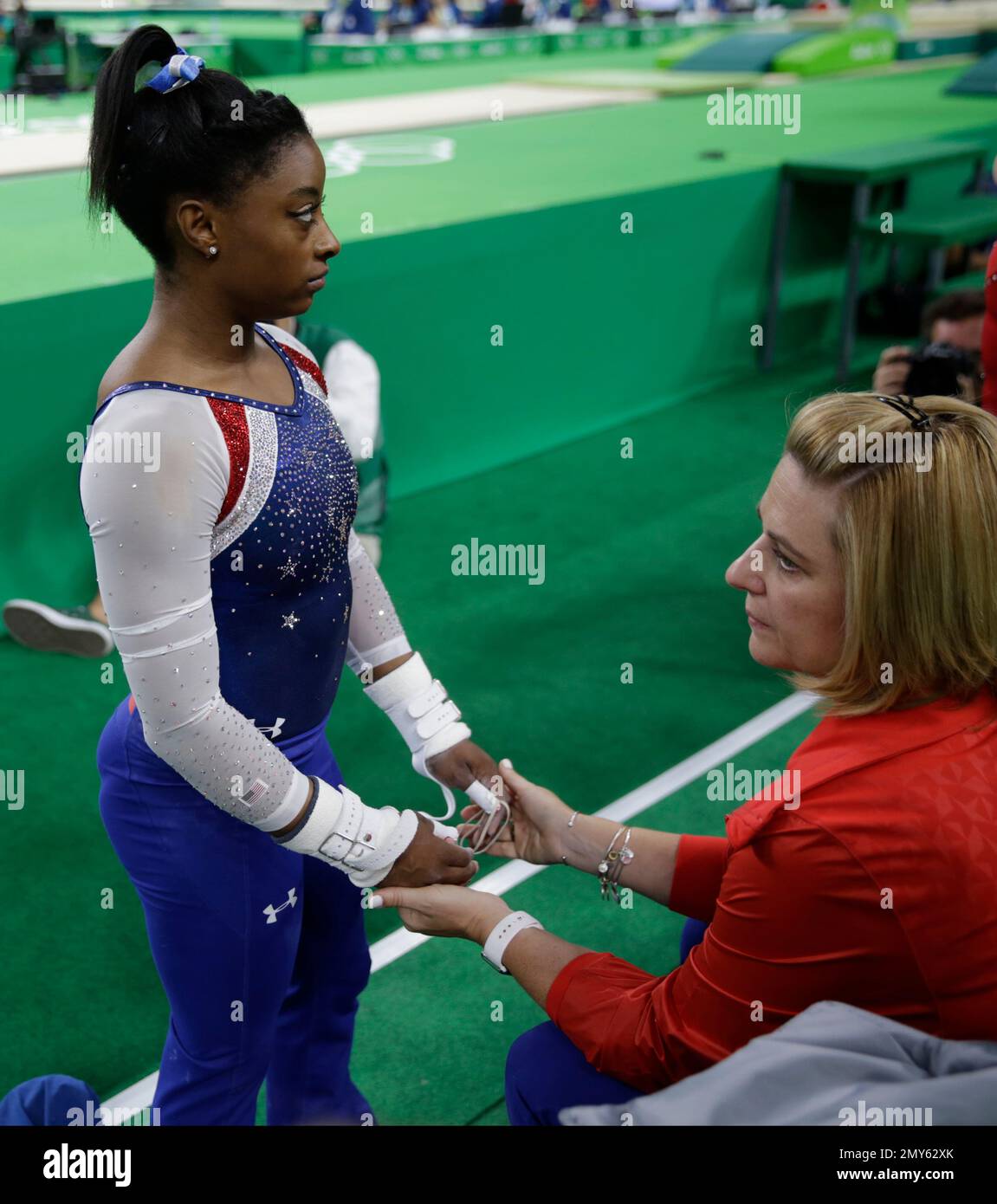 United States' Simone Biles holds hands with her coach Aimee Boorman ...
