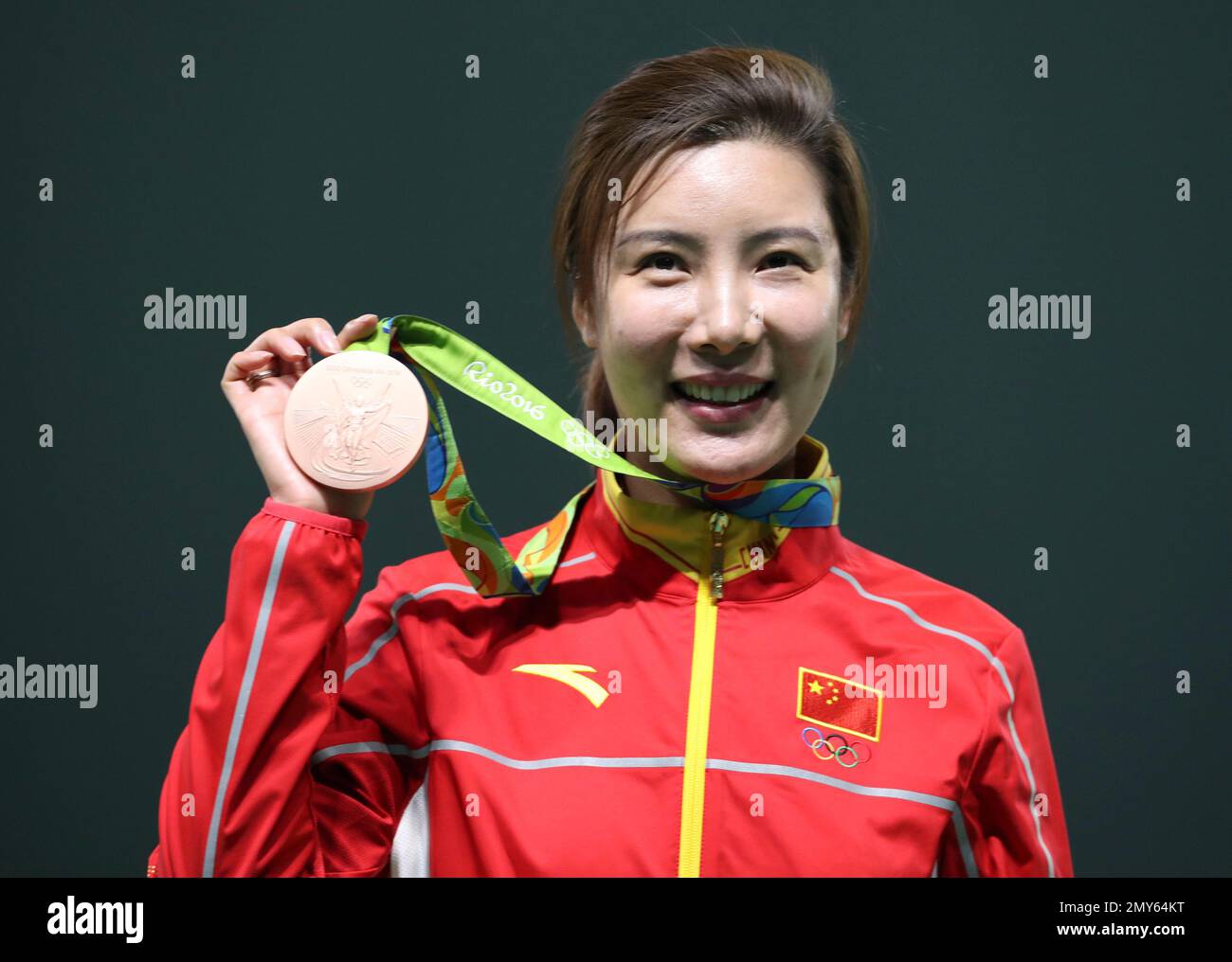 Du Li of China shows her bronze medal during the award ceremony for the ...