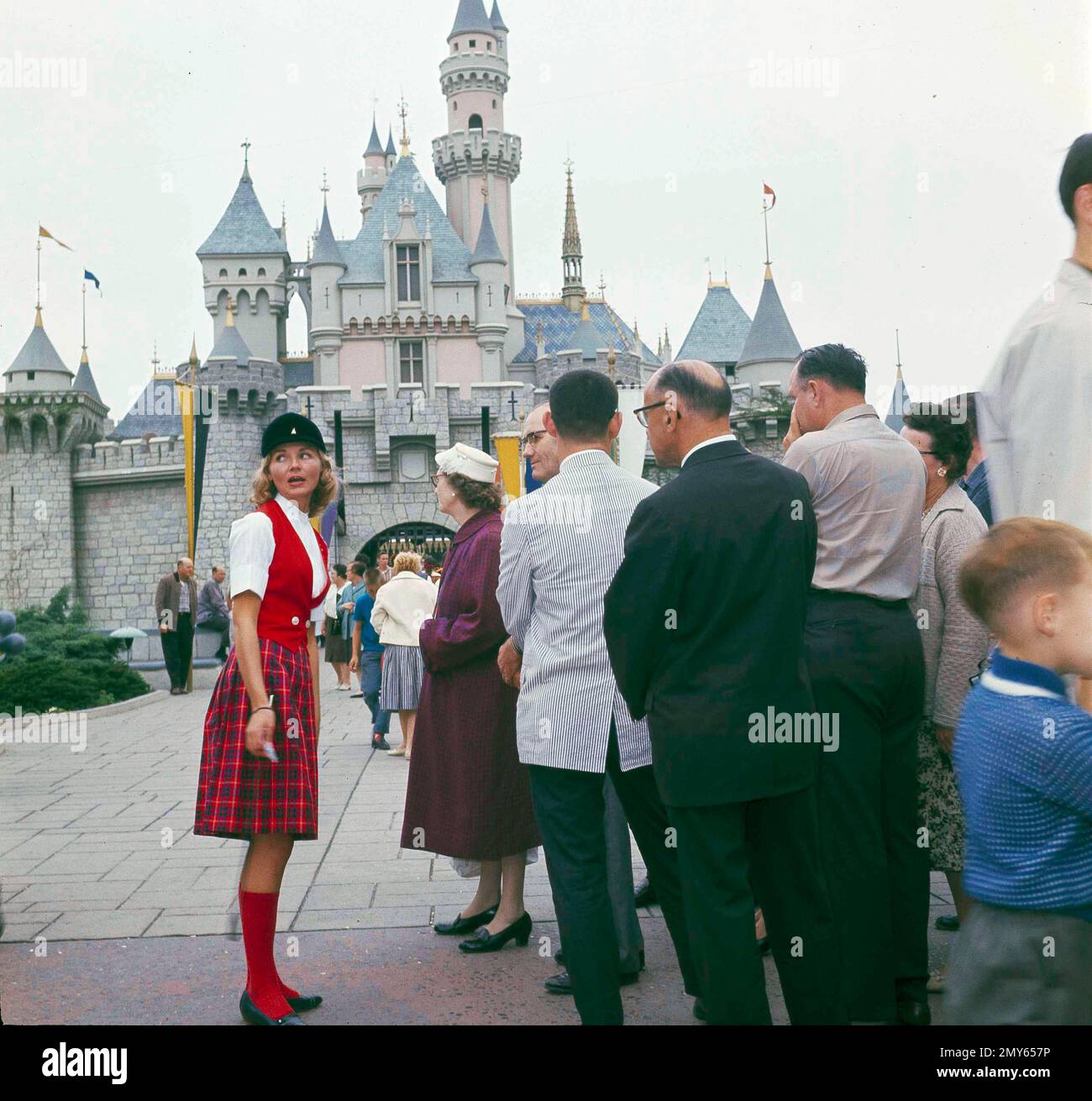 Disneyland guide Diane Stewart, left, stands with a group of tourists ...