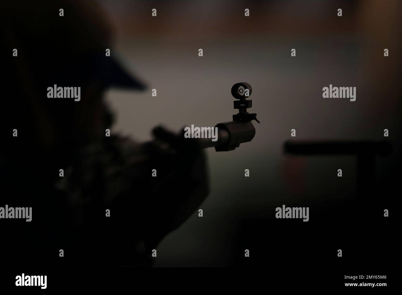 An athlete aims a target during the the women's 50 meter rifle 3 ...