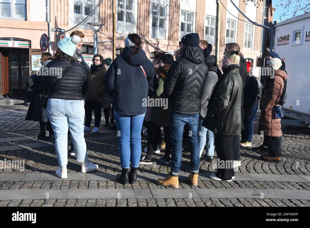 Copenhagen/Denmark/04 February 2023/ Tourists walking city guide tour ...