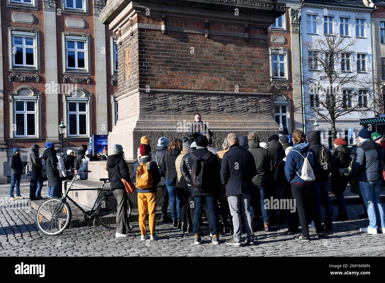 Copenhagen/Denmark/04 February 2023/ Tourists walking city guide tour ...