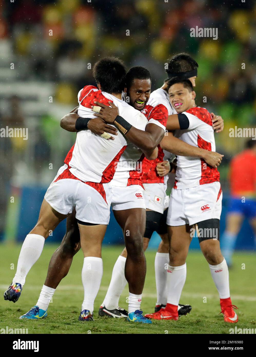 Japan's players celebrates winning the men's rugby sevens match against ...
