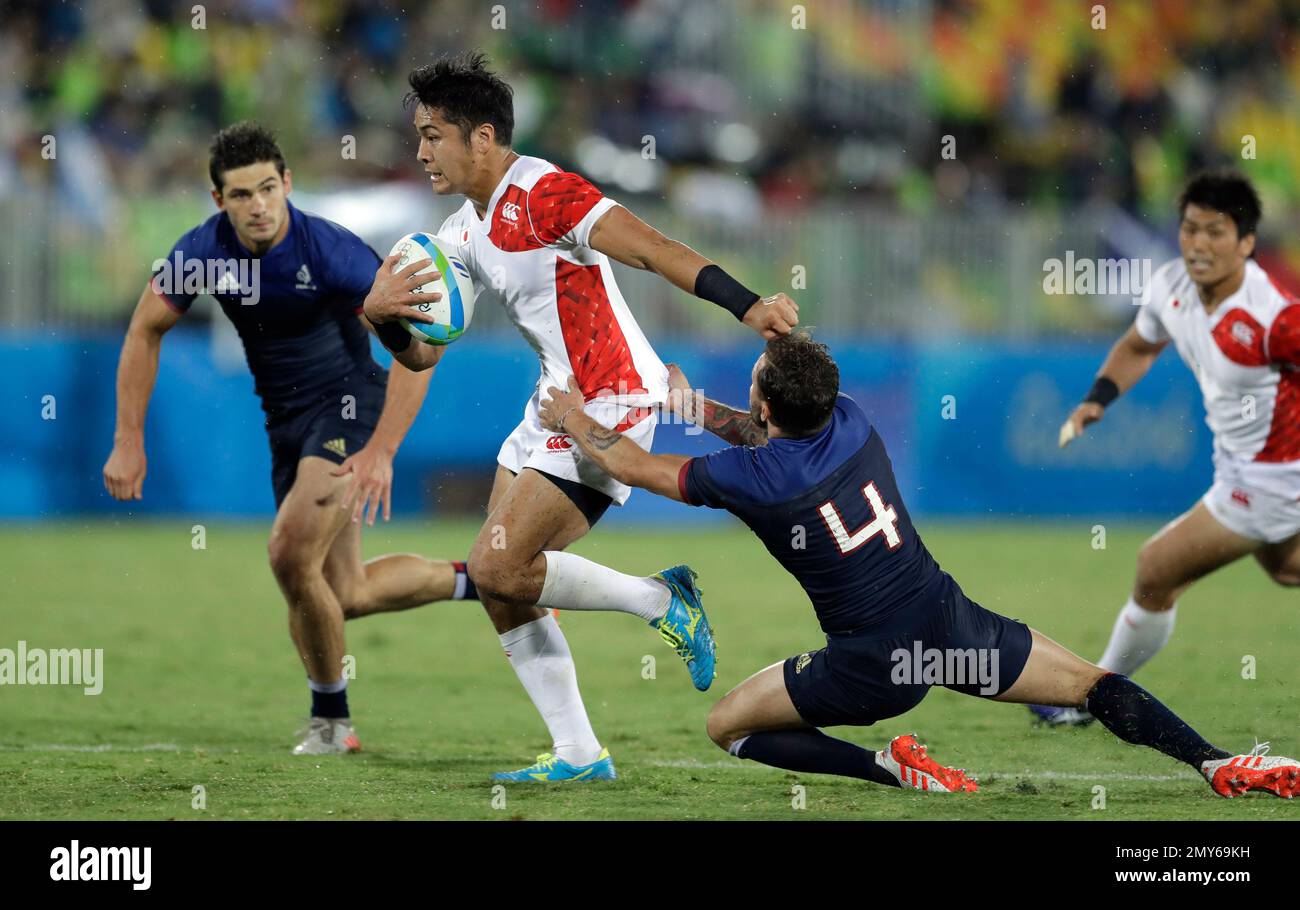 Japan's Teruya Goto, middle, avoids a tackle from France's Terry ...