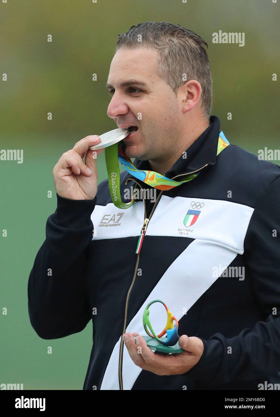 Marco Innocenti of Italy bites his silver medal during the award ...