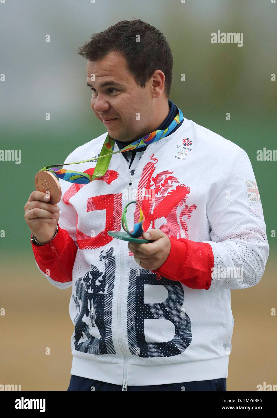 Steven Scott of Britain shows his bronze medal during the award ...