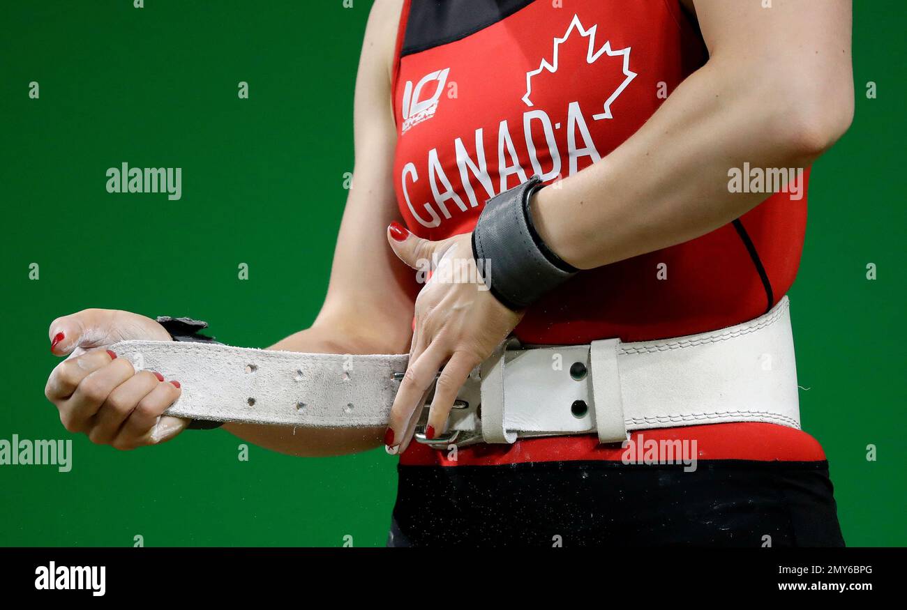 Marie-Eve Beauchemin-Nadeau, of Canada, puts on her belt before ...