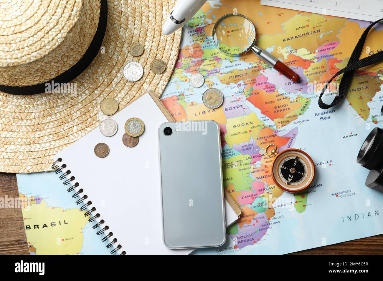 Different items on world map, flat lay. Travel during summer vacation ...