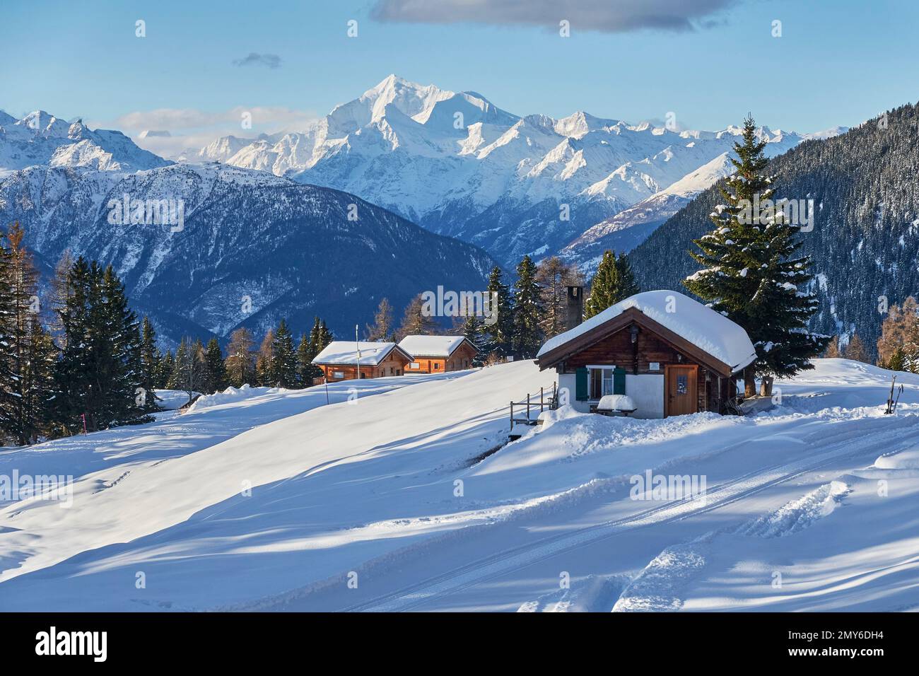 A landscape view of the small huts nestled between the snowy mountains ...