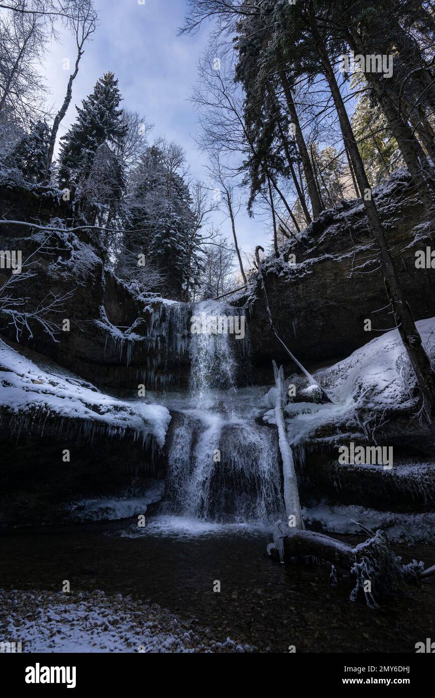 Icy waterfall with icicles hanging down from the rocks besides Stock ...
