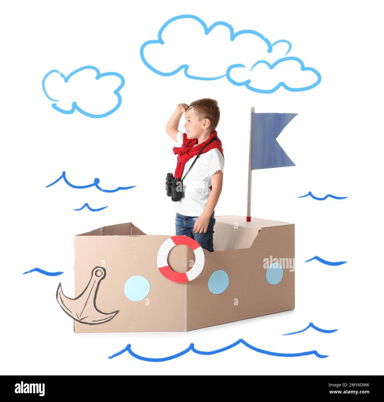 Cute little boy playing in cardboard ship on white background with ...