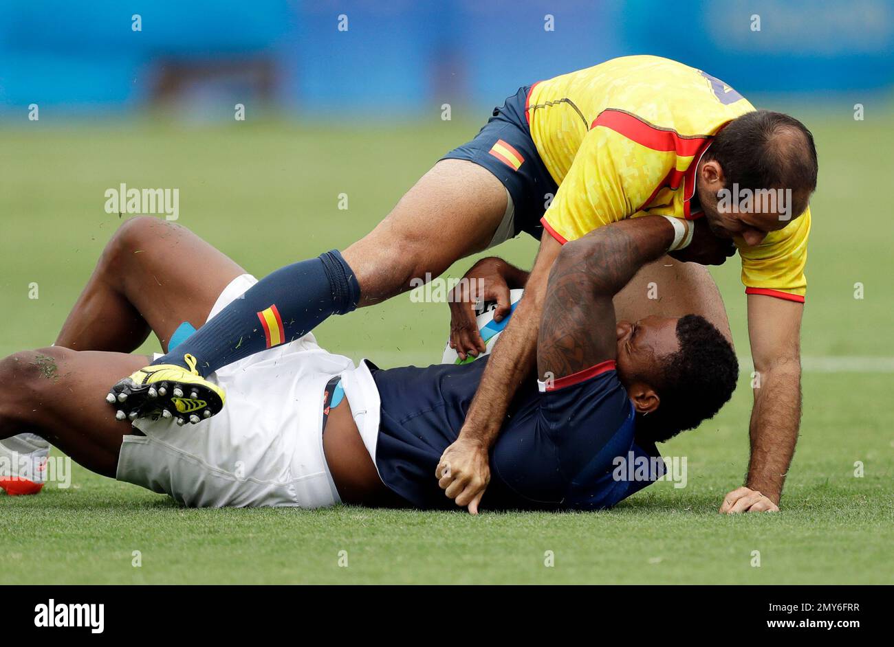 France's Virimi Vakatawa, bottom, is tackled by Spain's Pablo Feij'o ...
