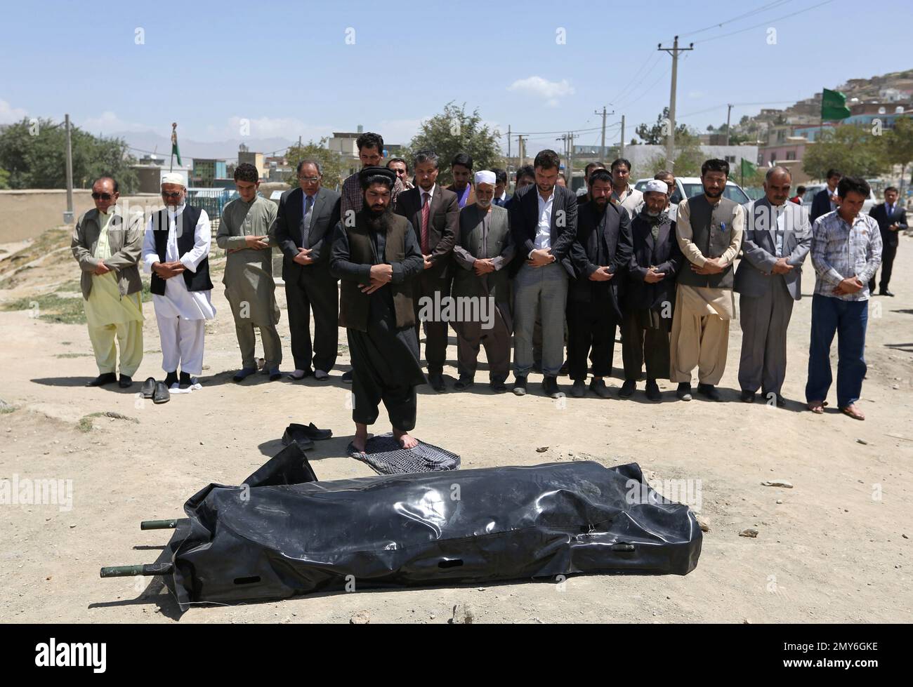 Afghans pray during the funeral of Zarah, 14, who was pregnant, who ...