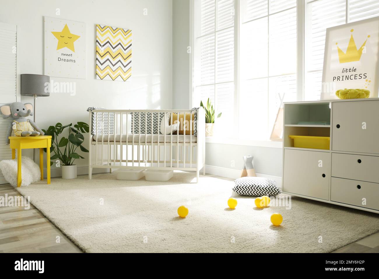 Cute baby room interior with crib and big window Stock Photo - Alamy