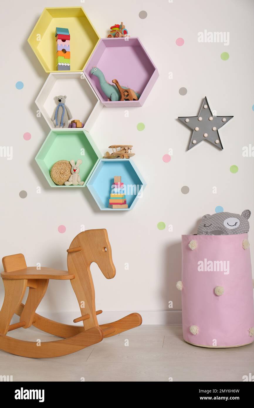 Bright colorful shelves on light wall in room. Interior design Stock ...